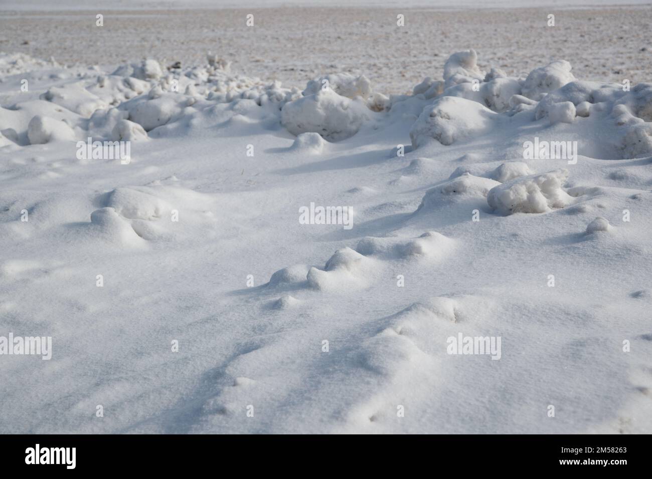 clumps of snow on the side of the road Stock Photo - Alamy