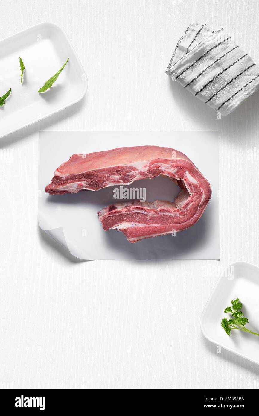 Veal ribs on a kitchen with some herbs from above Stock Photo - Alamy