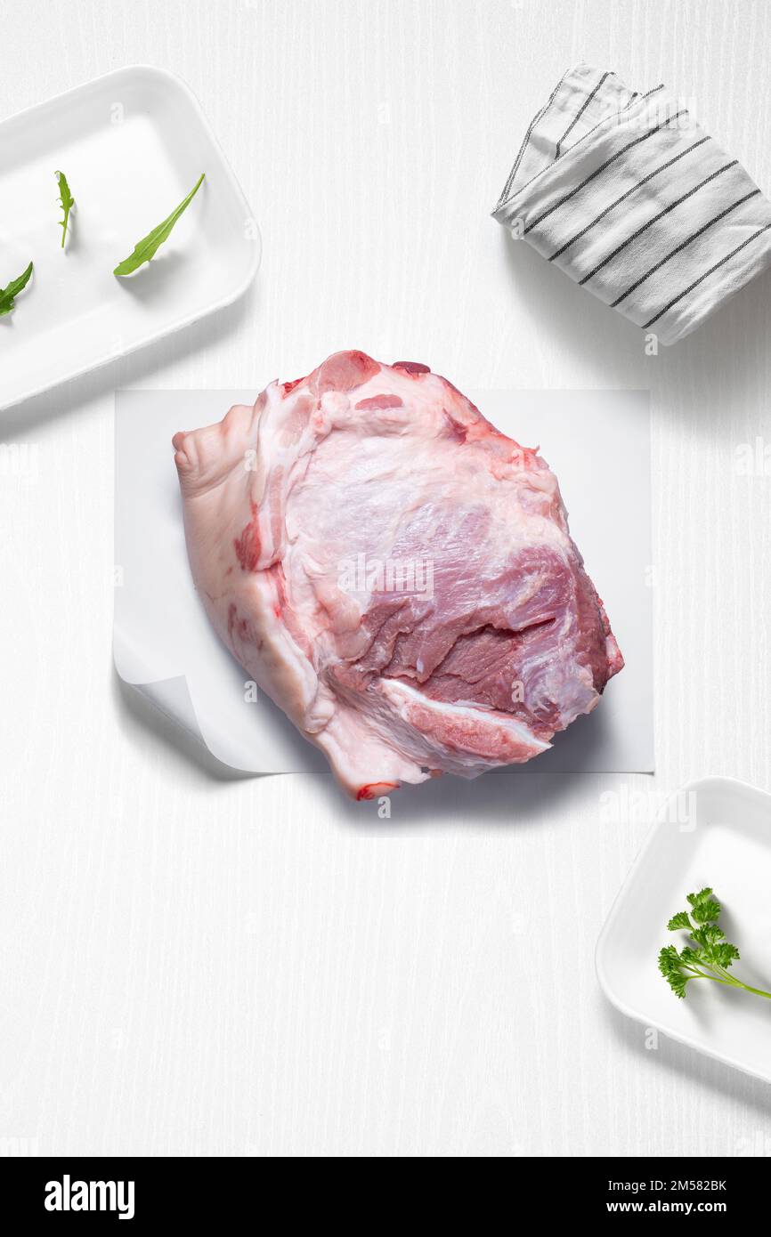 Whole pork garter on a kitchen with some herbs from above Stock Photo ...