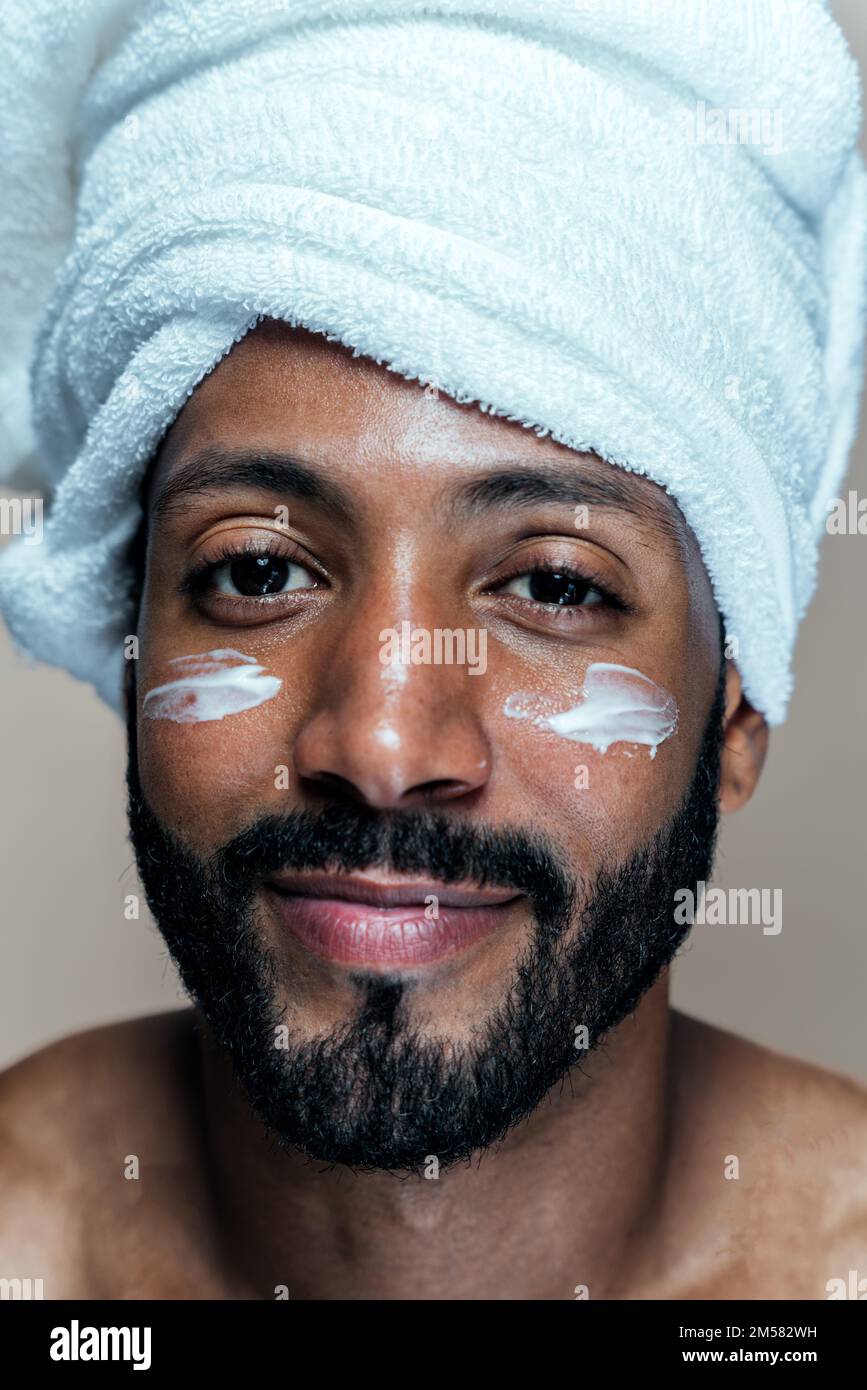 Image of a young man taking care of his skin. Beauty studio shot about ...