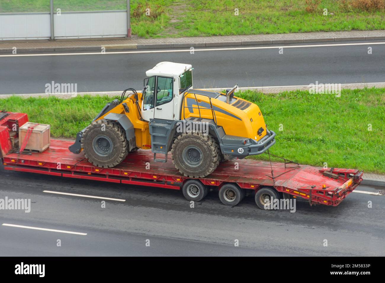 Truck with a long trailer platform for transporting heavy machinery ...
