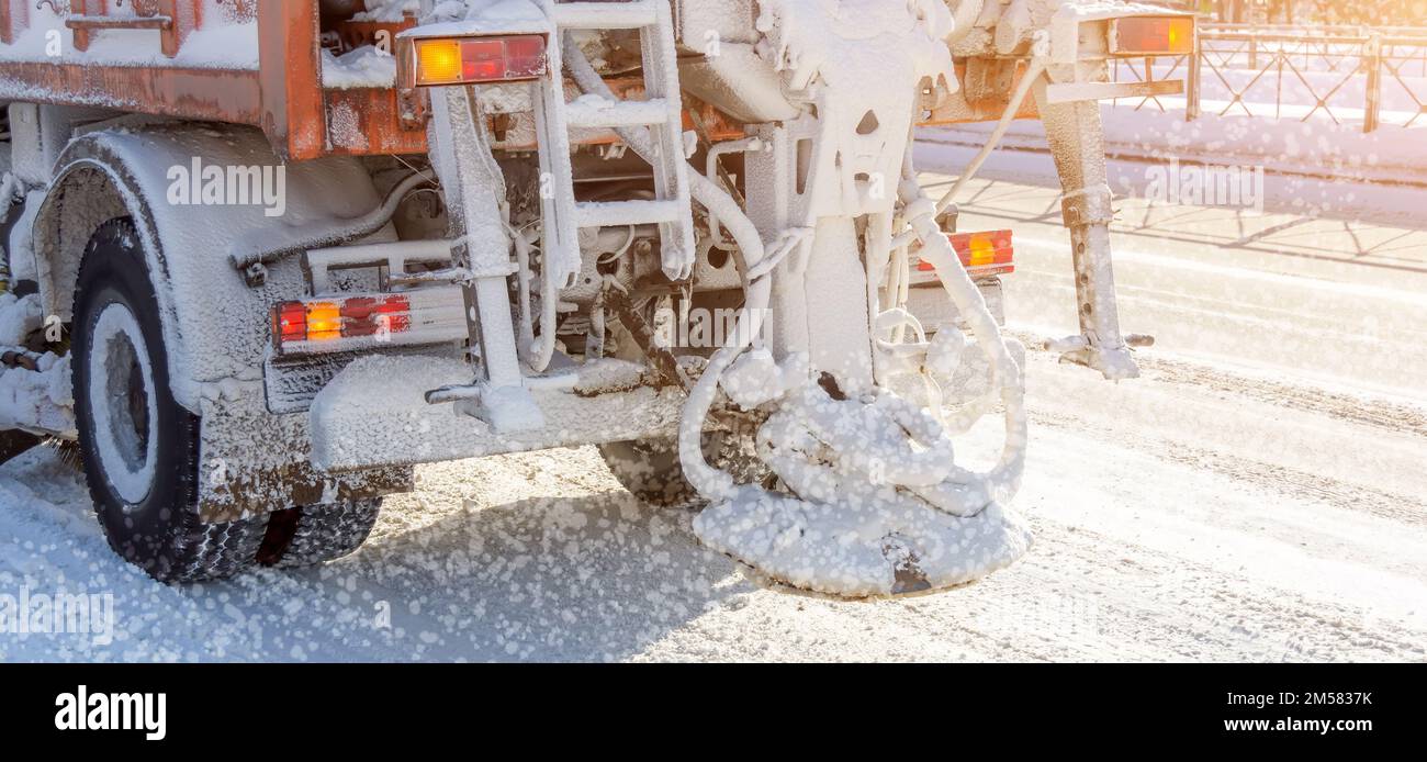 Snow plow on highway salting road. Orange truck deicing street ...