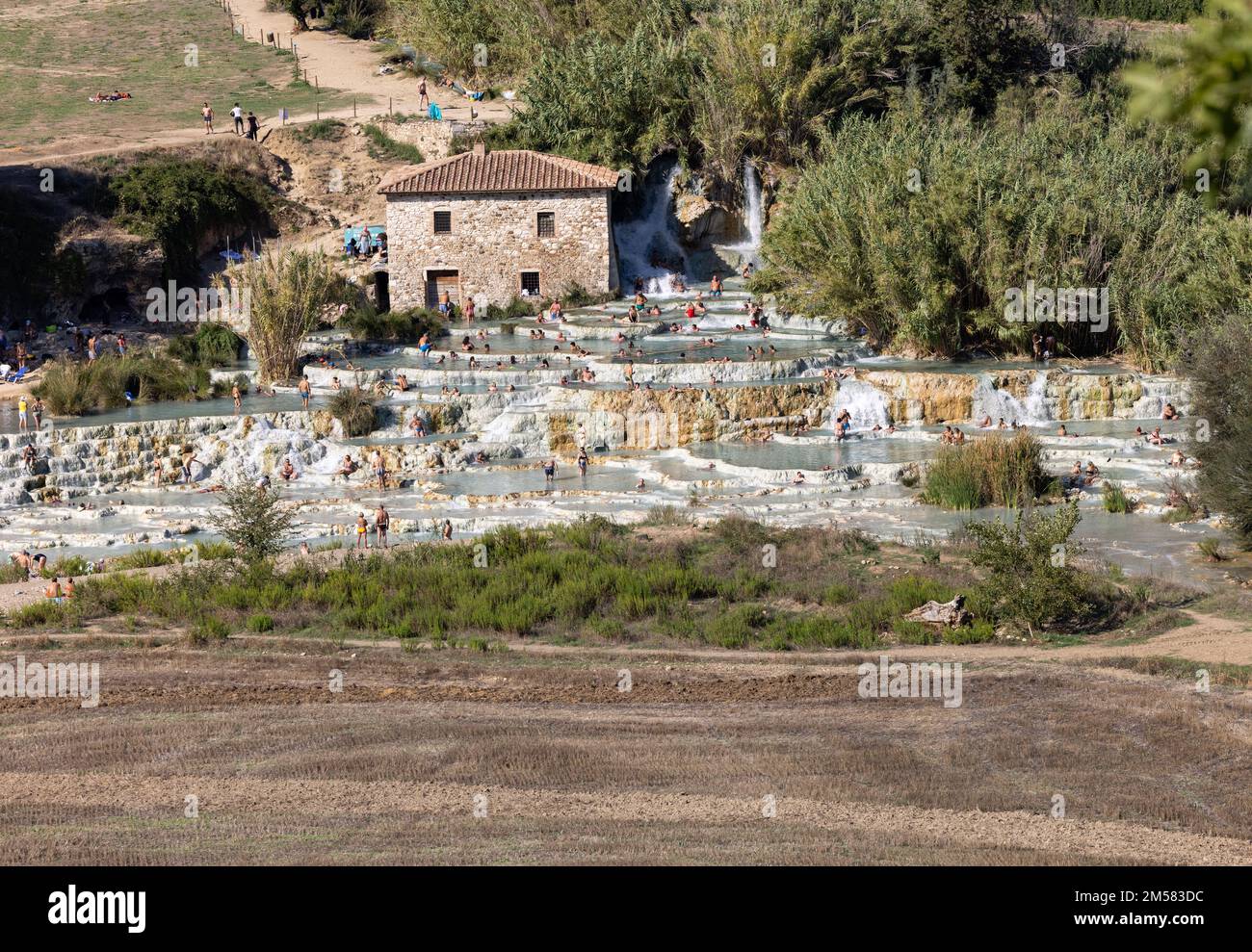 Saturnia, Italy - September 13, 2022: People are bathing in the hot ...