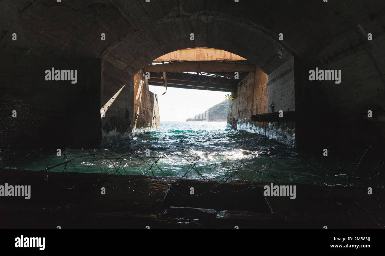Exit gate of a concrete undergrounf tunnel, part of abandoned submarine ...