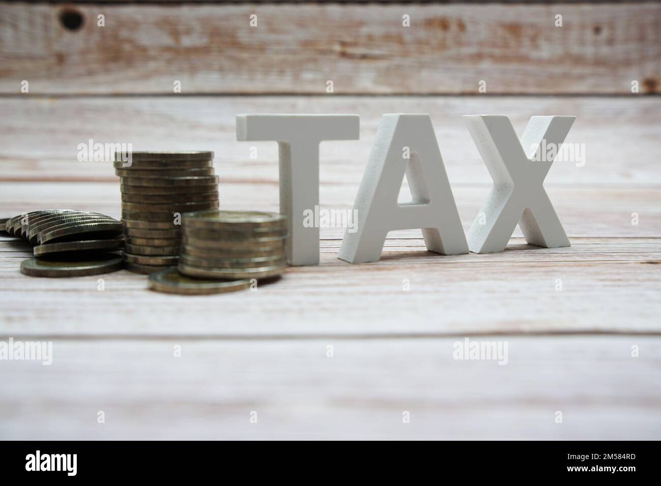 TAX alphabet letters with coin stack on wooden background Stock Photo ...