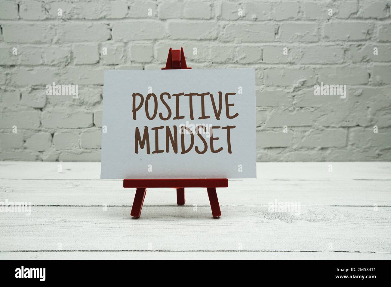 Positive Mindset text on white brick wall and wooden background Stock ...