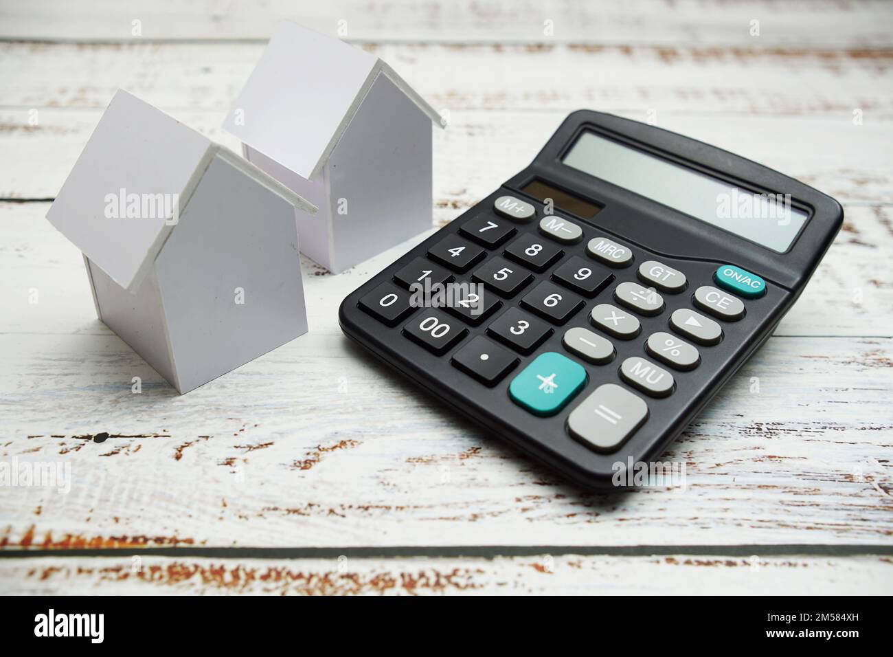 Model House and calculator on wooden background, realestate concept ...