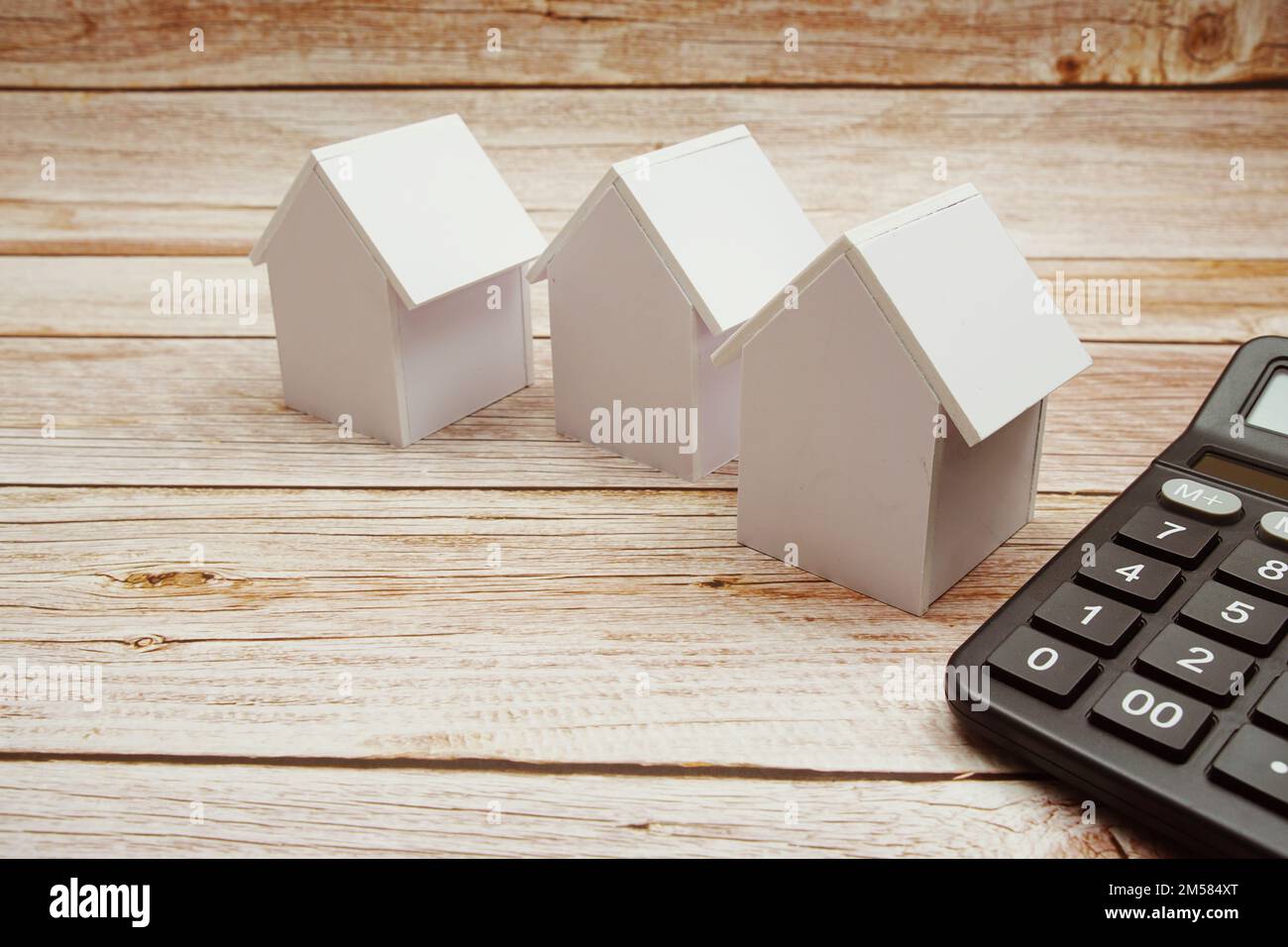 Model House and calculator on wooden background, realestate concept ...
