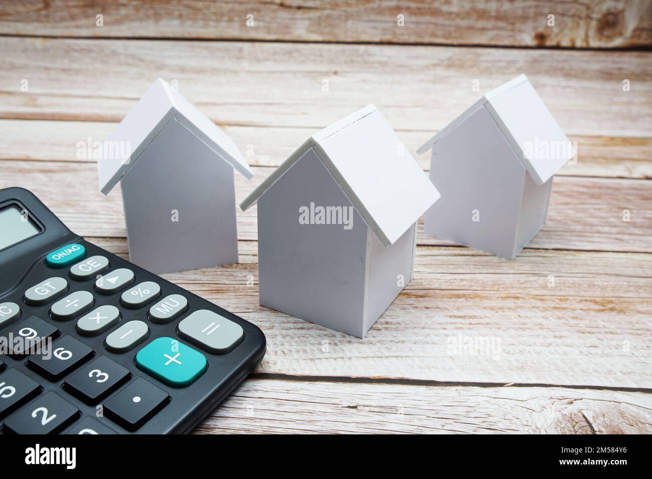 Model House and calculator on wooden background, realestate concept ...
