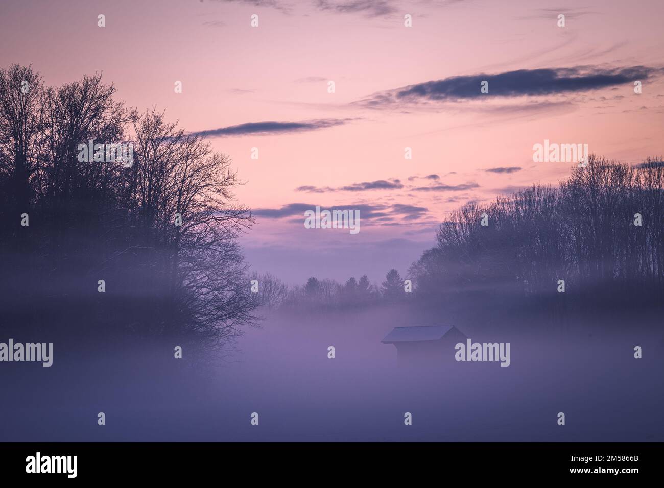 A scenic view of fog wraps the landscape in colorful color in the ...
