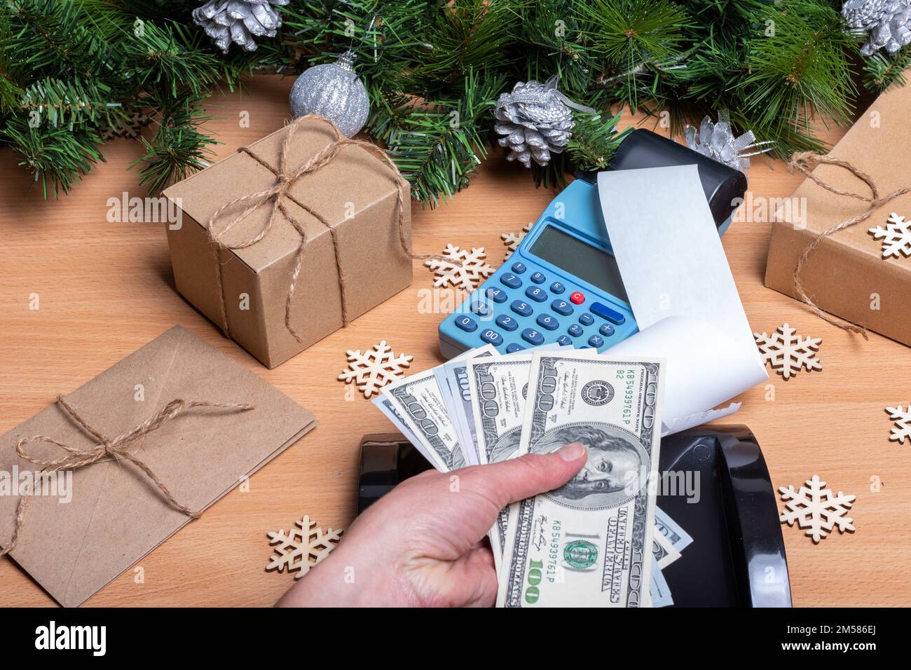 Christmas sale. The hand holds cash to pay for gifts for the holidays ...