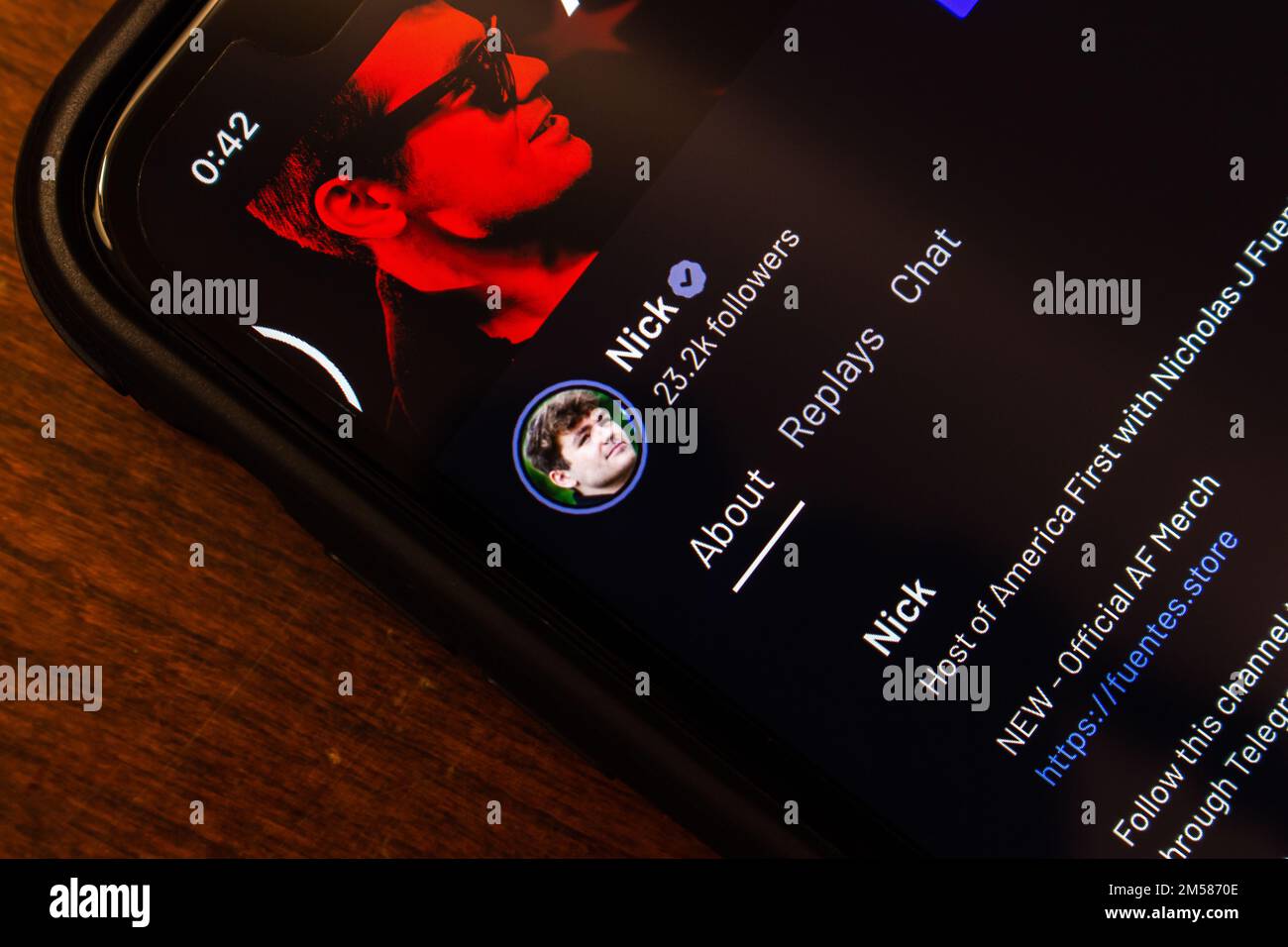 Nick Fuentes channel page in cozy.tv seen in an iPhone screen. Nicholas ...