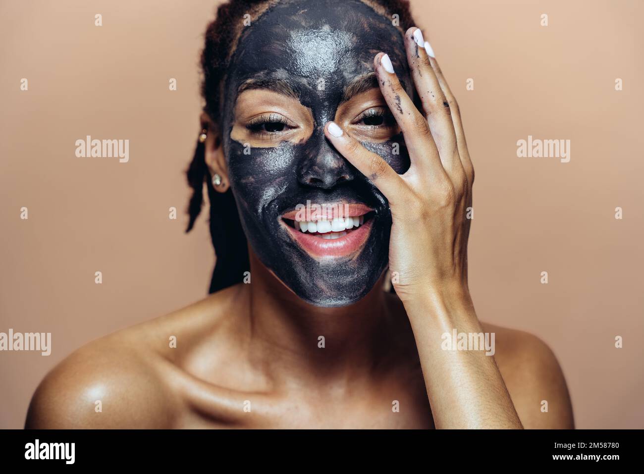 Beautiful woman making skin and facial beauty treatments. Studio shot ...