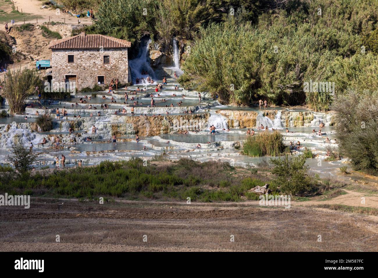 Saturnia, Italy - September 13, 2022: People are bathing in the hot ...
