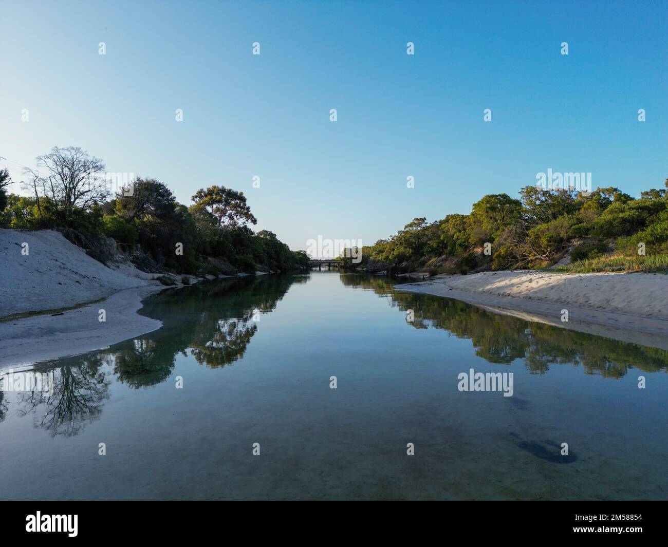 A reflecting river between trees with blue sky on a summer day Stock ...