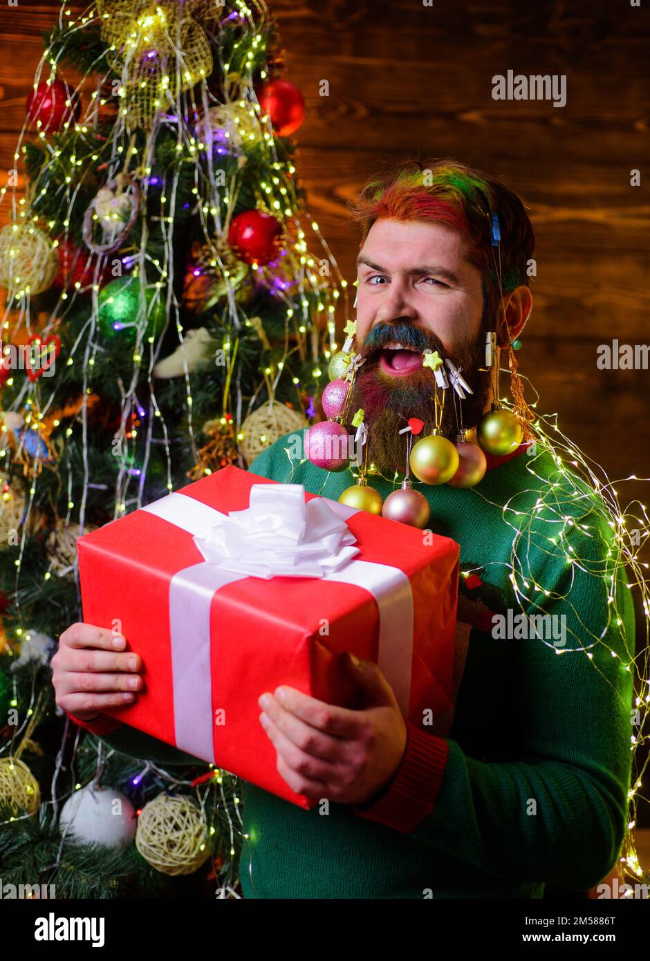 Bearded man with decorated beard for New Year party. Christmas present ...