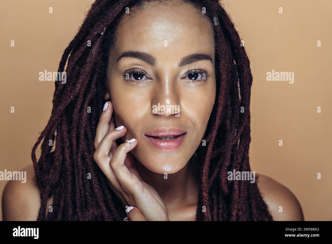 Beautiful woman making skin and facial beauty treatments. Studio shot ...