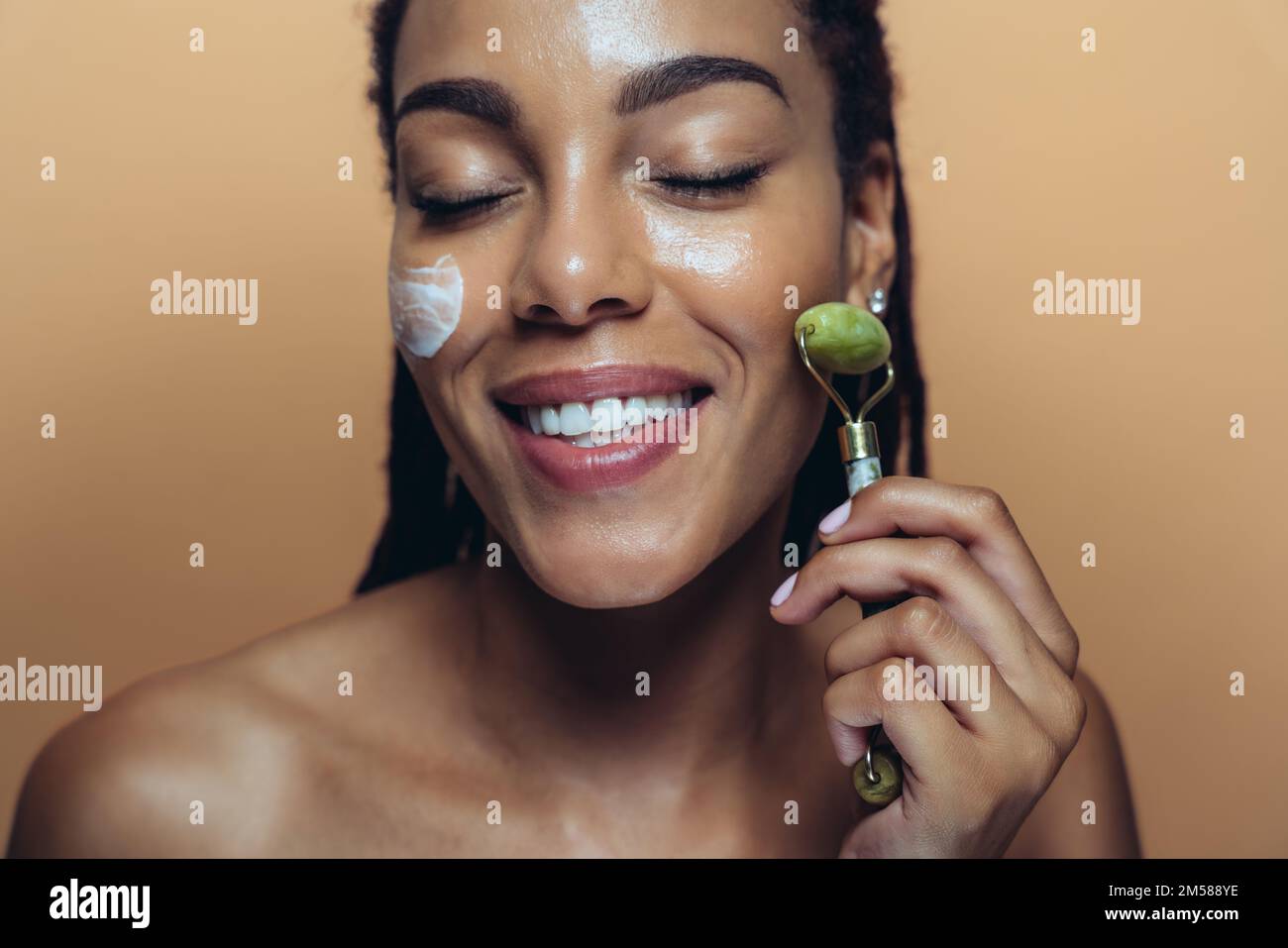 Beautiful woman making skin and facial beauty treatments. Studio shot ...