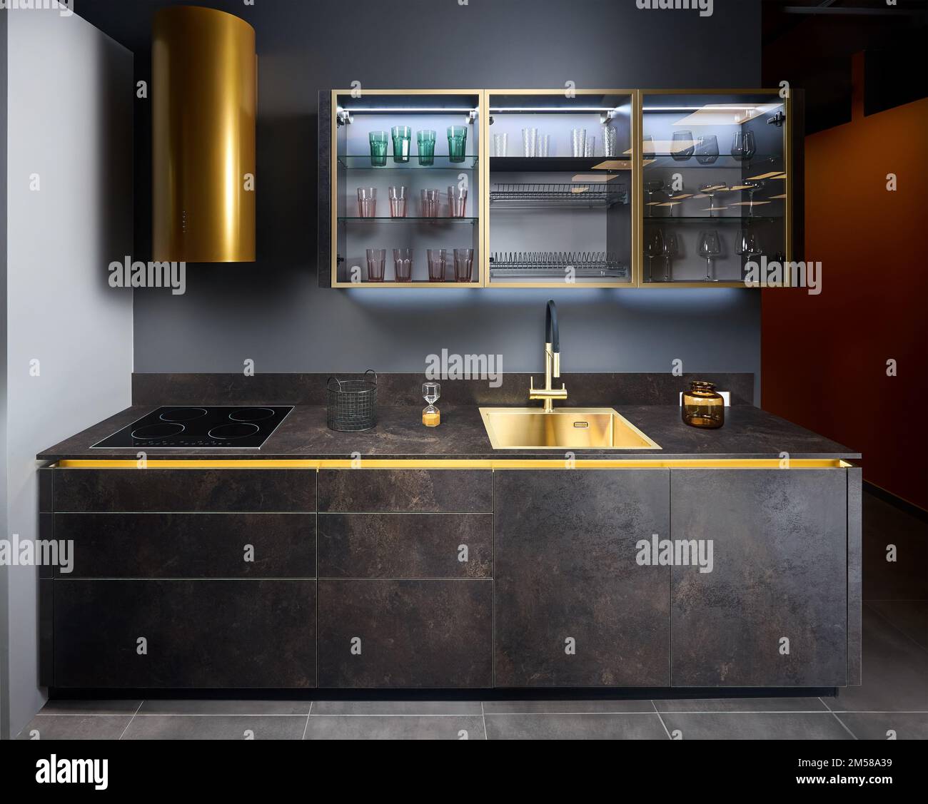 Upscale flat design kitchen with induction black glass hob with ...