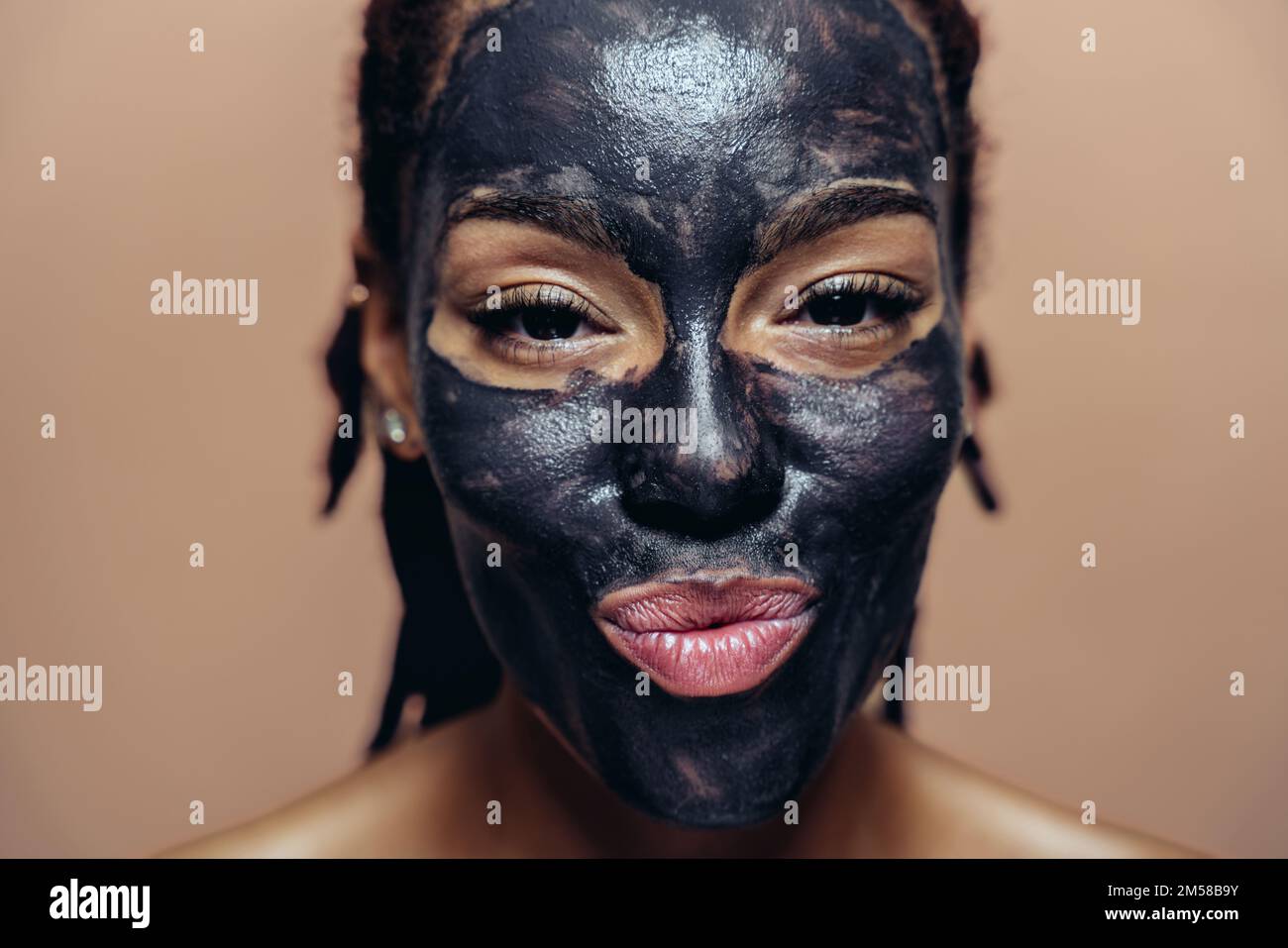 Beautiful woman making skin and facial beauty treatments. Studio shot ...