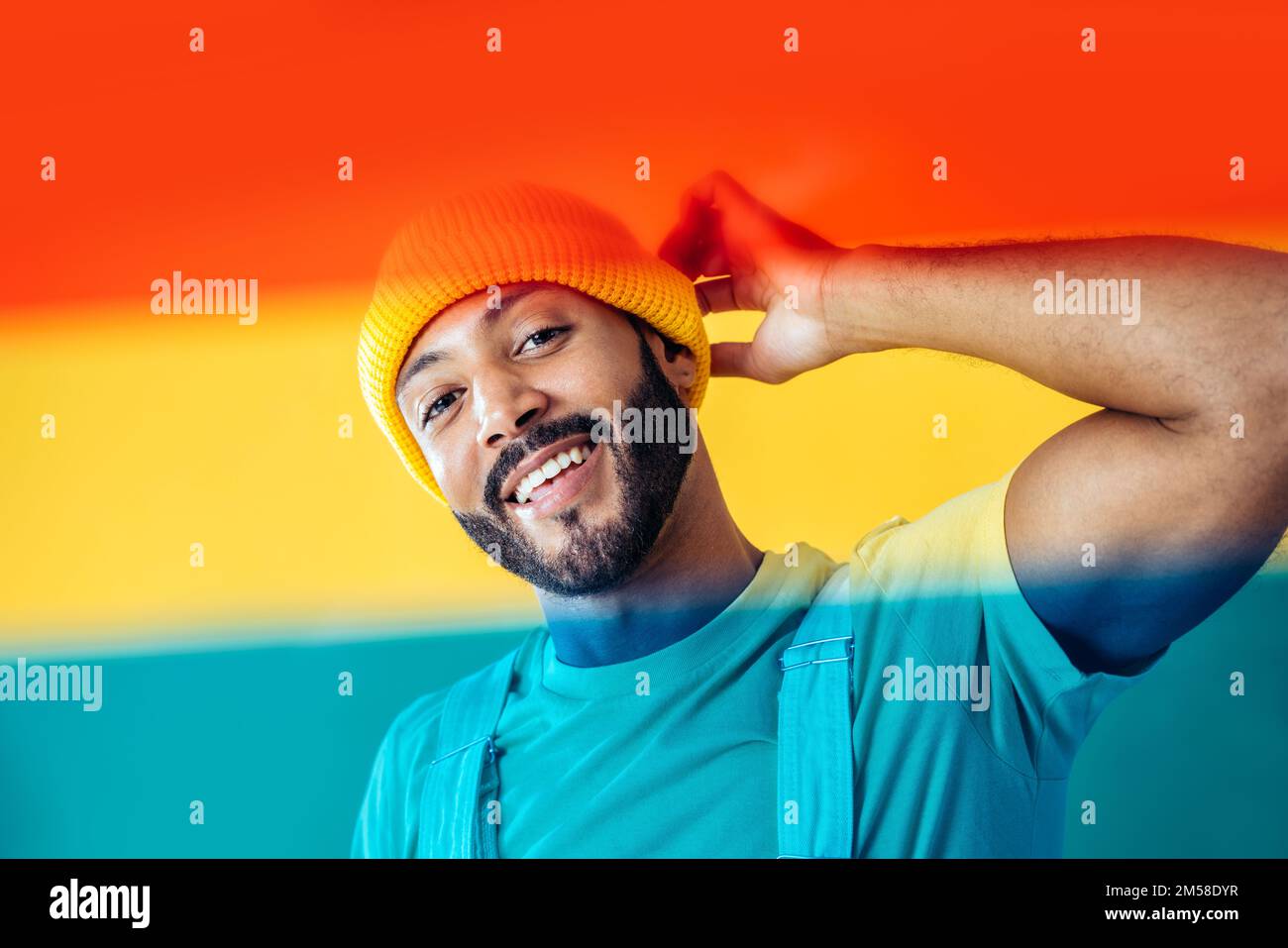 Image of an handsome young man posing on colored backgrounds wearing ...