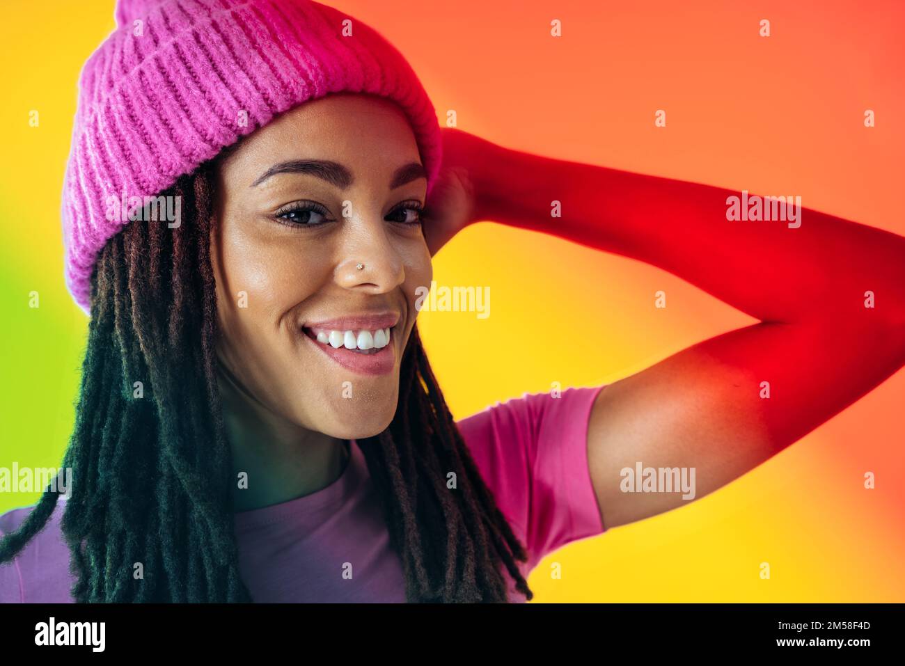 Image of a beautiful young woman posing on colored backgrounds wearing ...