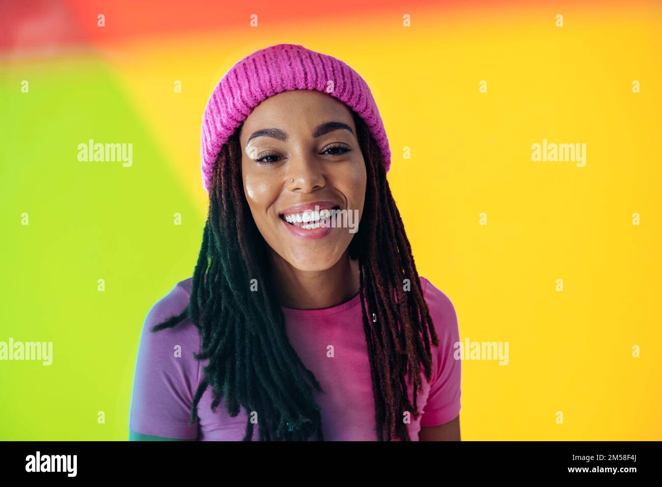 Image of a beautiful young woman posing on colored backgrounds wearing ...