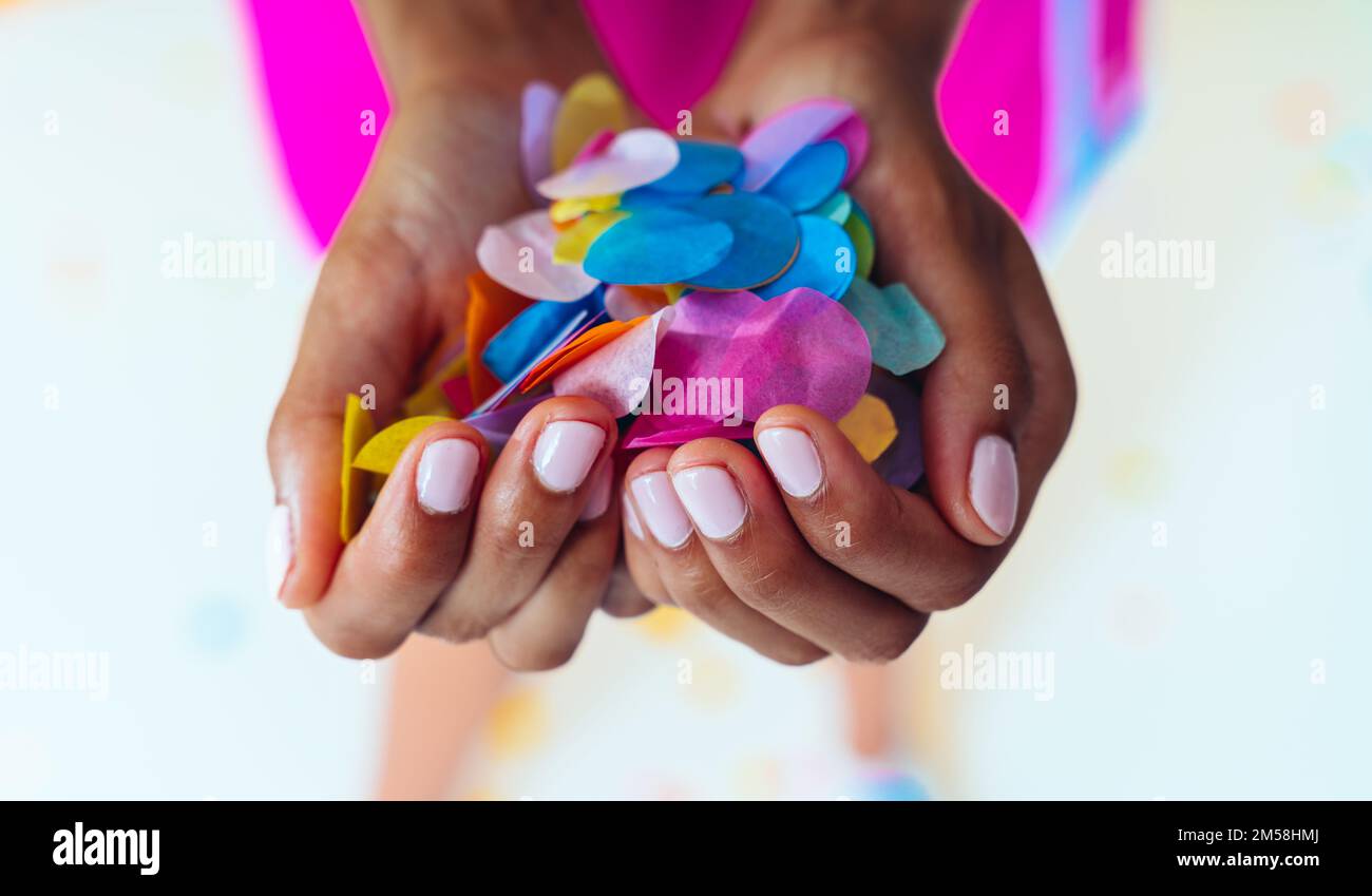 Hands full of confetti ready to be cast in the air. Concept about party ...