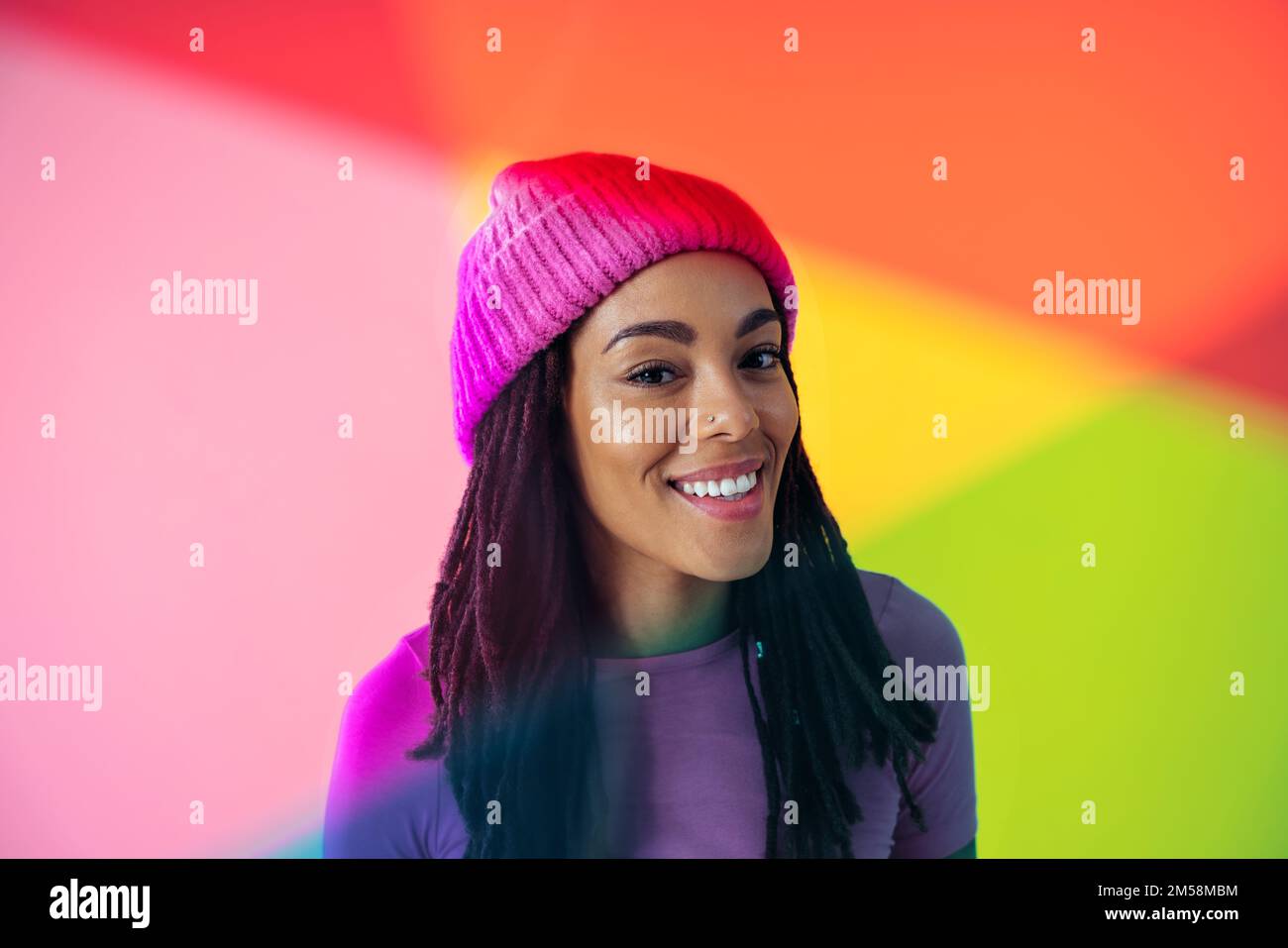 Image of a beautiful young woman posing on colored backgrounds wearing ...