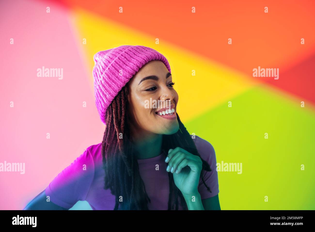 Image of a beautiful young woman posing on colored backgrounds wearing ...