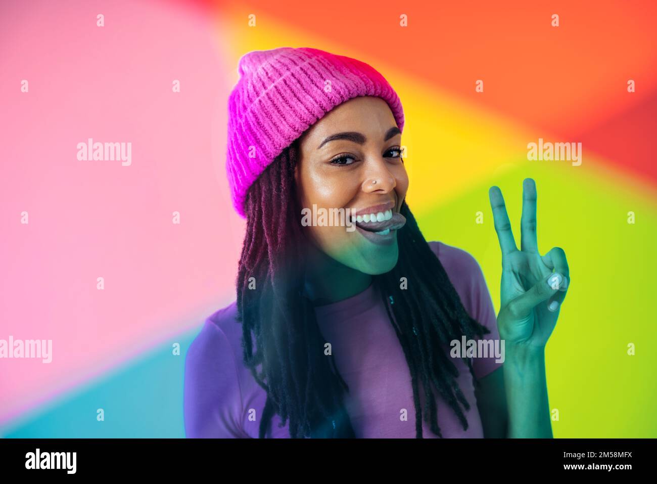 Image of a beautiful young woman posing on colored backgrounds wearing ...