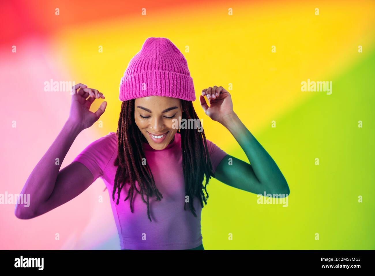 Image of a beautiful young woman posing on colored backgrounds wearing ...