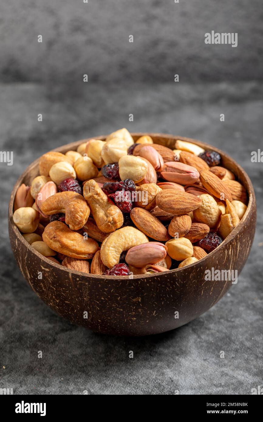 Mixed nuts in bowl on dark background. Nuts, cashews, almonds and ...