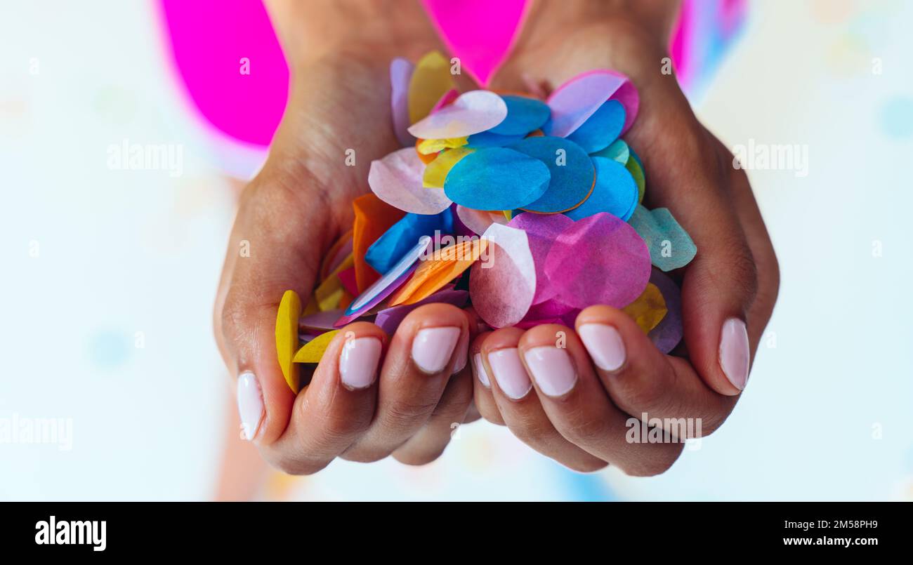 Hands full of confetti ready to be cast in the air. Concept about party ...