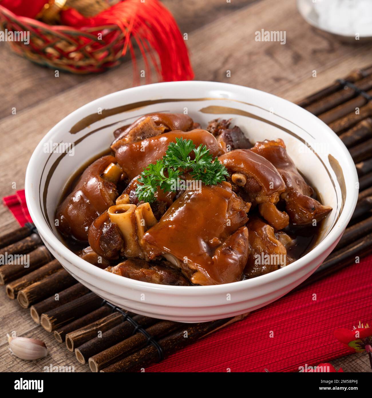 Taiwanese traditional food pork knuckle in a white bowl with golden ...