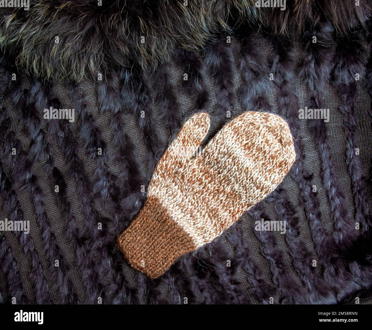 Brown-beige handmade mittens from Argentinean merino wool on a natural ...