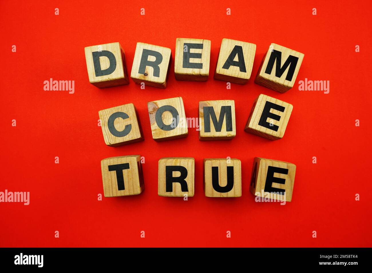 dream come true word created with cubes alphabet letters on red ...