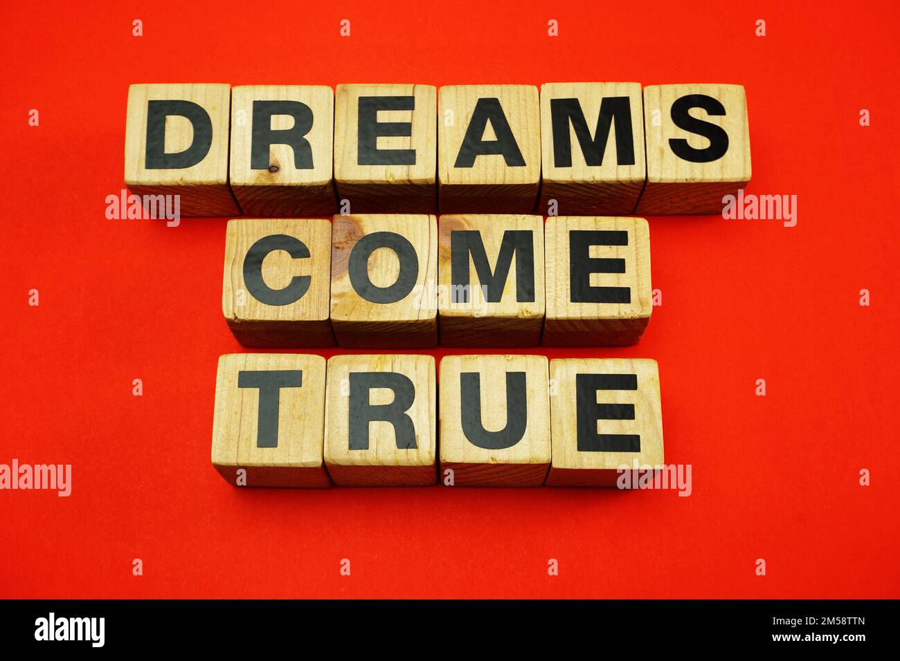 dream come true word created with cubes alphabet letters on red ...