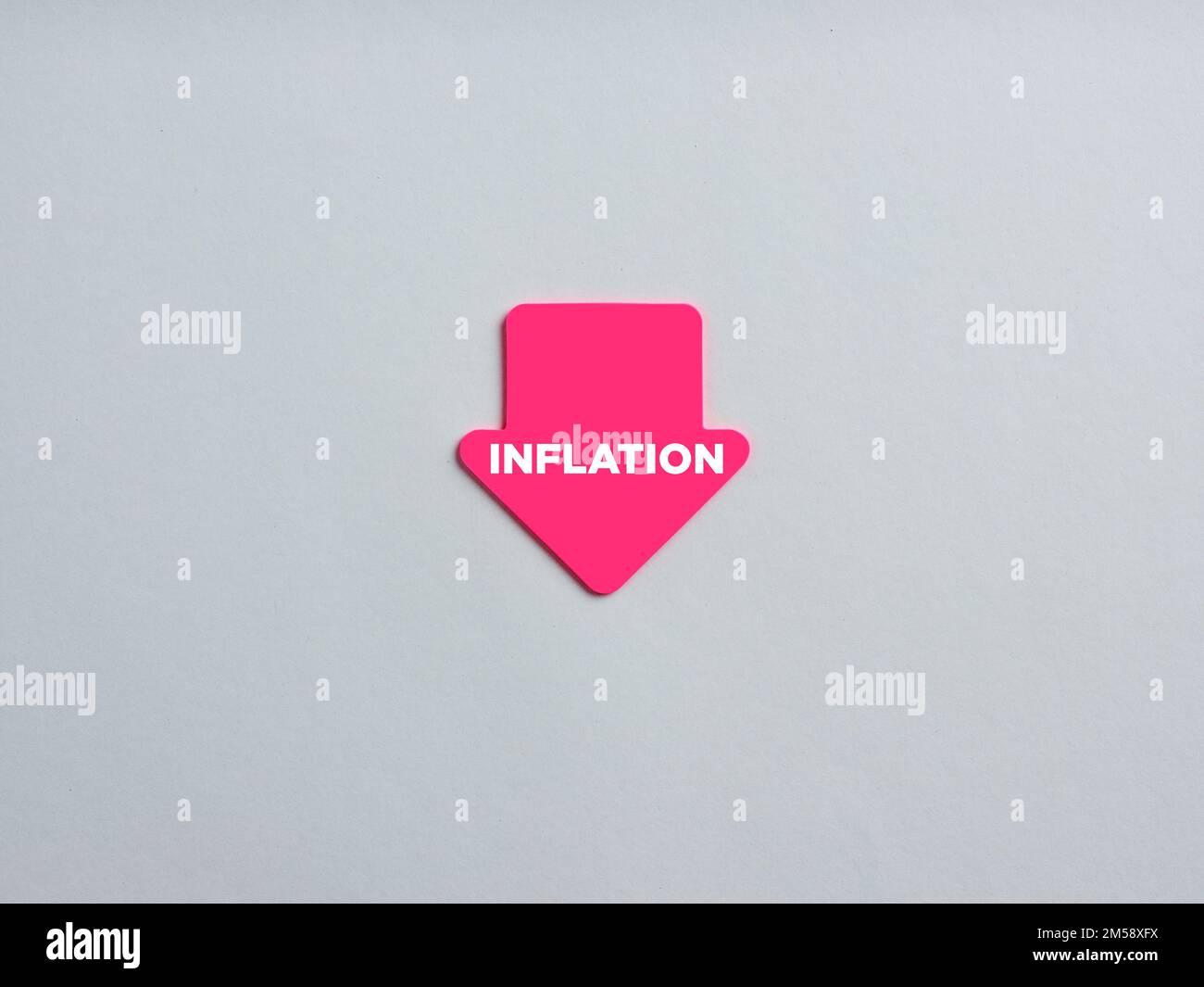 Inflation rate is falling or slowing down. Arrow shaped note paper with ...