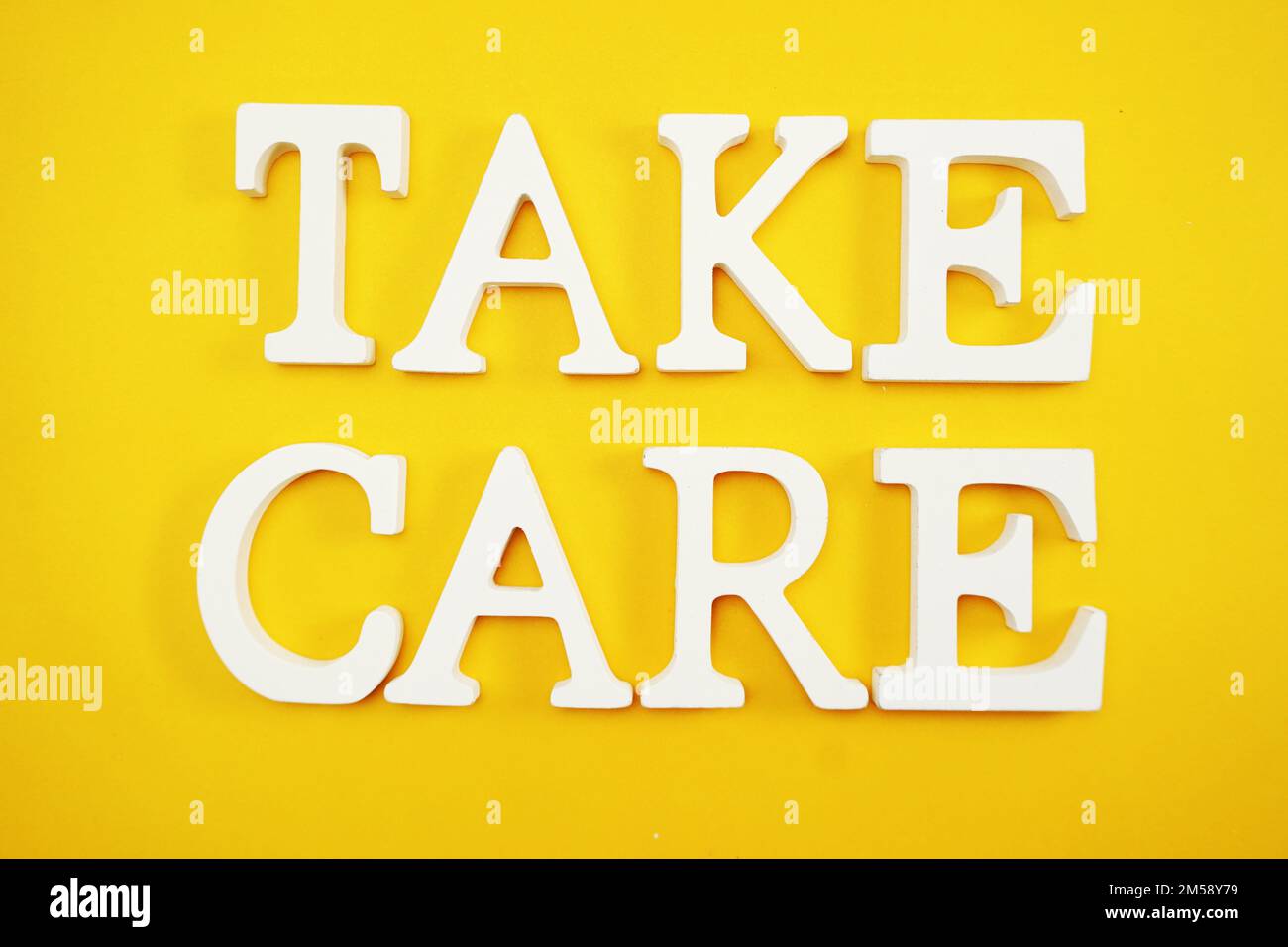 words take care alphabet with white letters on yellow background Stock ...
