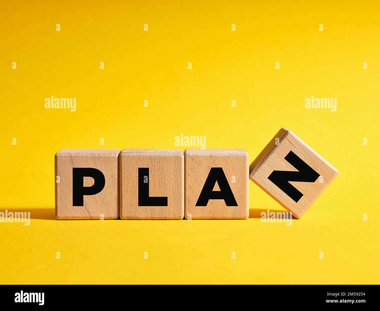 The word Plan on wooden cubes with yellow background. Planning for ...