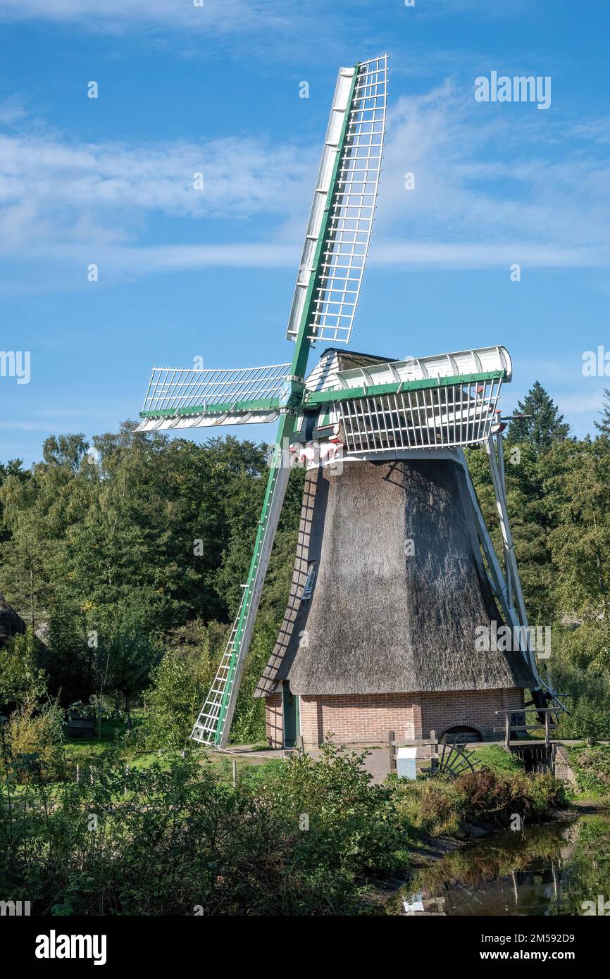 A vertical shot of a beautiful old windmill in the farmland Stock Photo ...