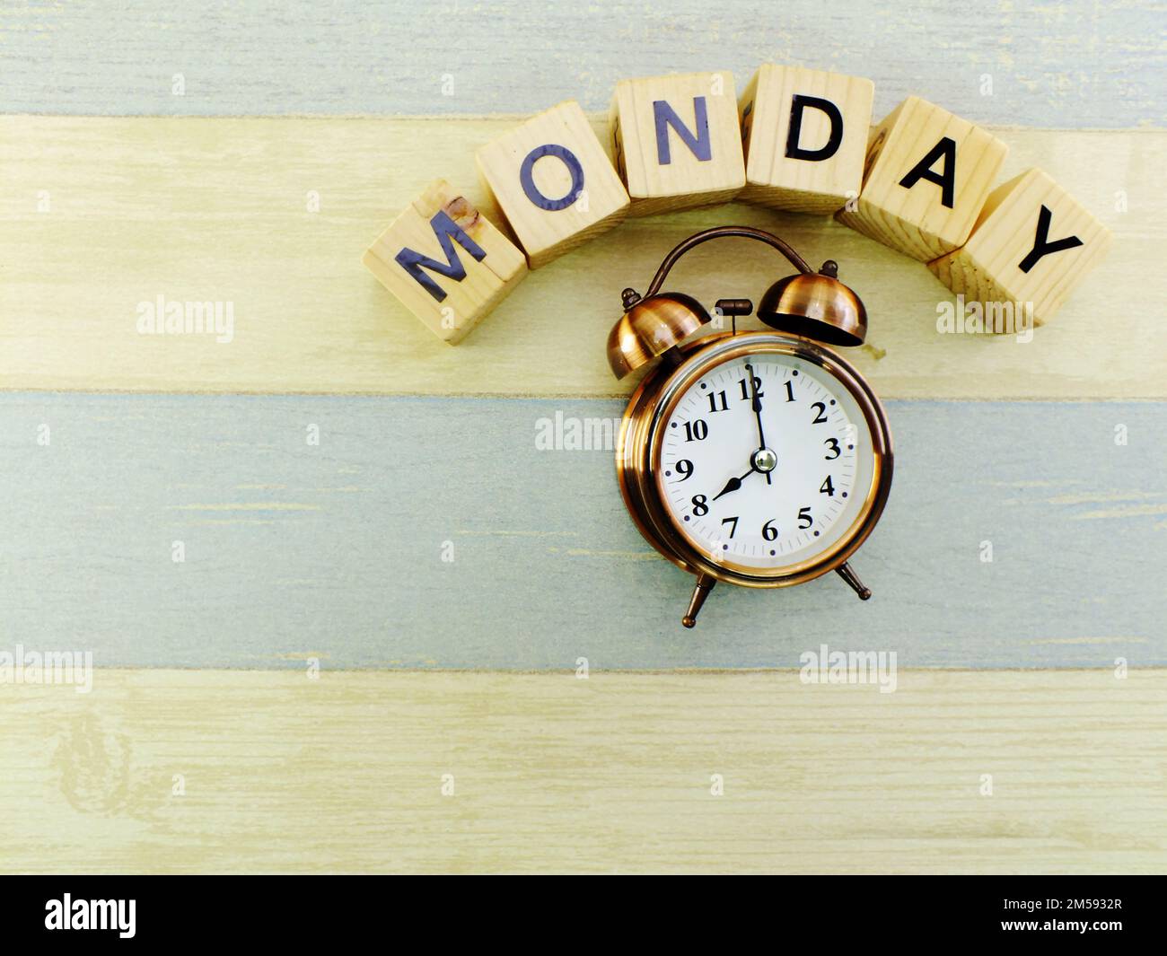 monday cube wooden block and alarm clock top view with space background ...