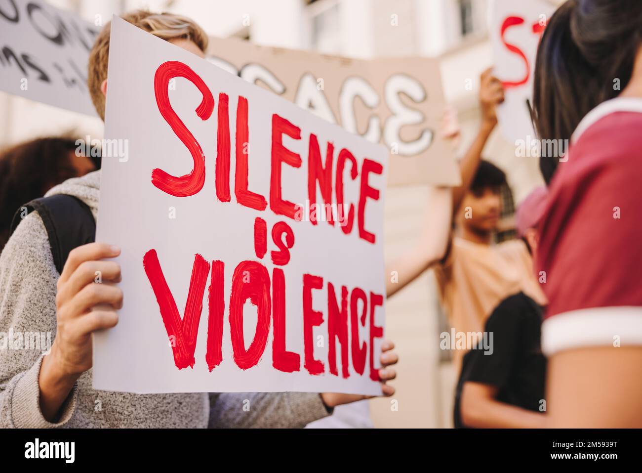 Youth activists marching against war and violence in the streets. Group ...