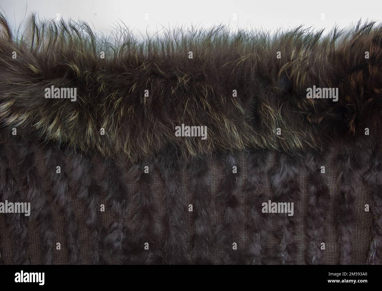Background from dark brown fur and wool. Combined knitted fur product ...