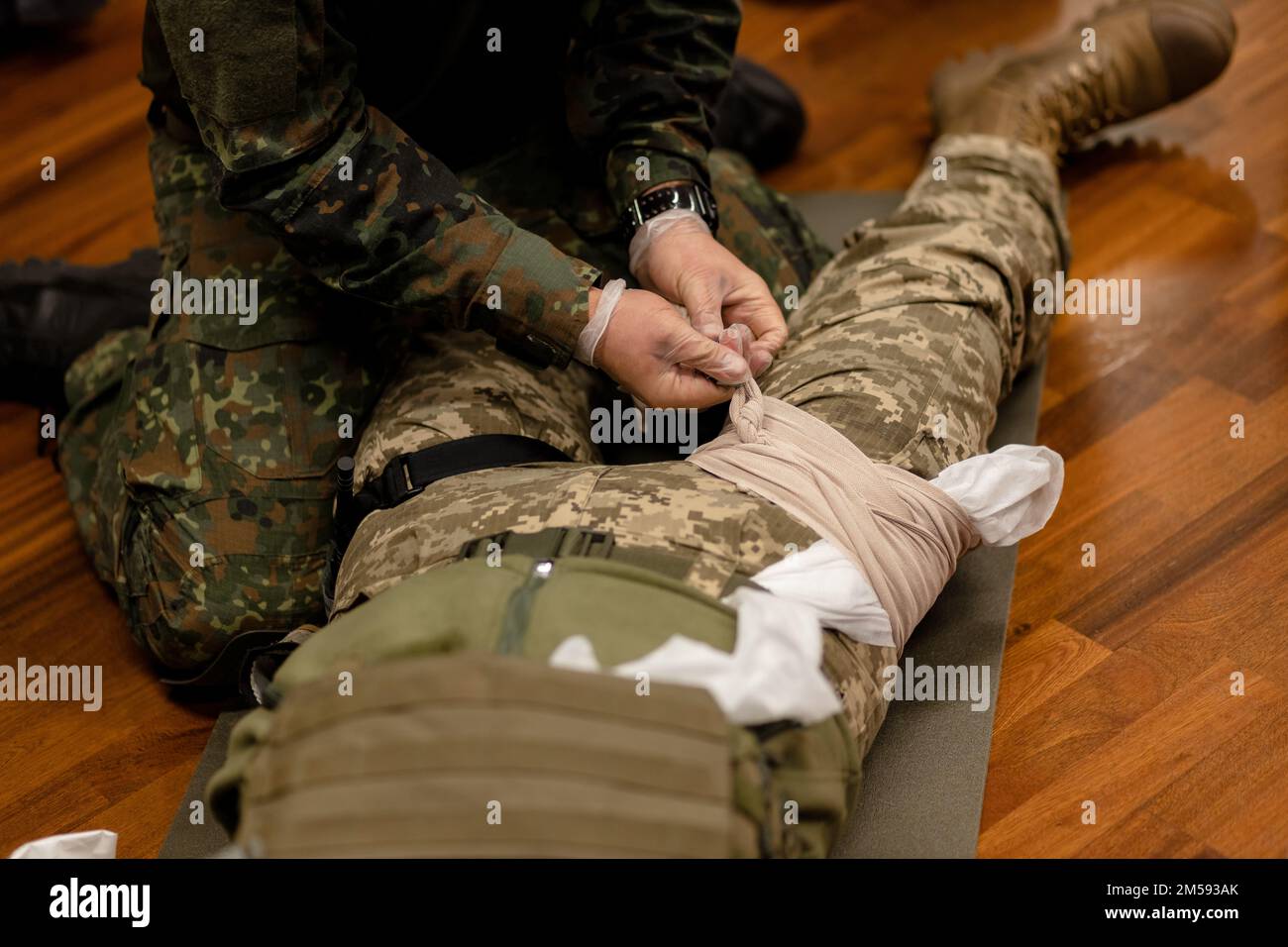 Training dressing of the wounded leg of a Ukrainian fighter, close-up ...