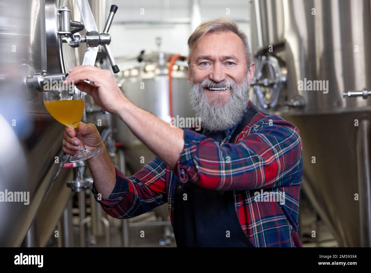 Brewery owner pouring some beer from the tanks Stock Photo - Alamy
