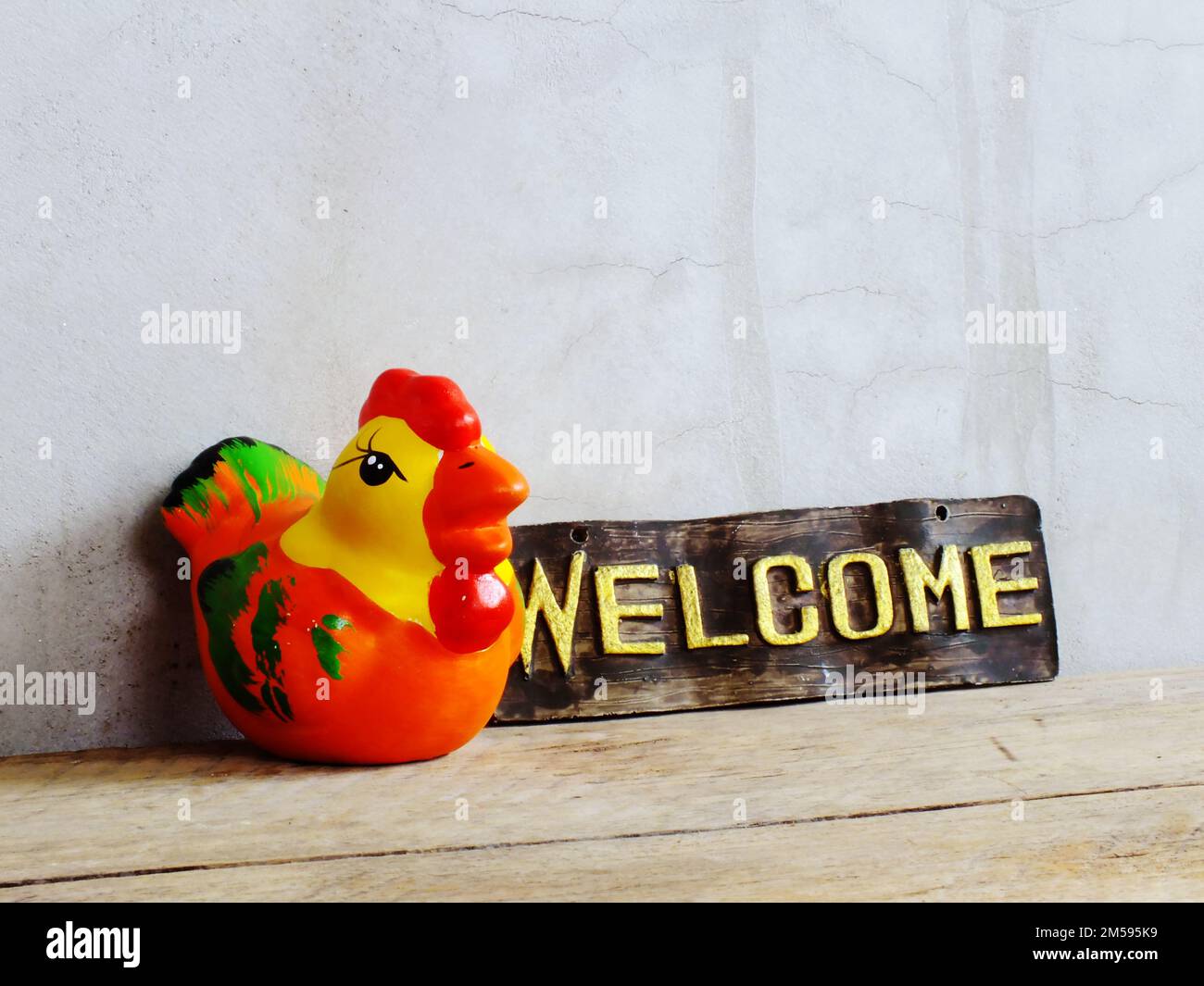 cute ceramic chicken hen with welcome sign on wooden background Stock ...