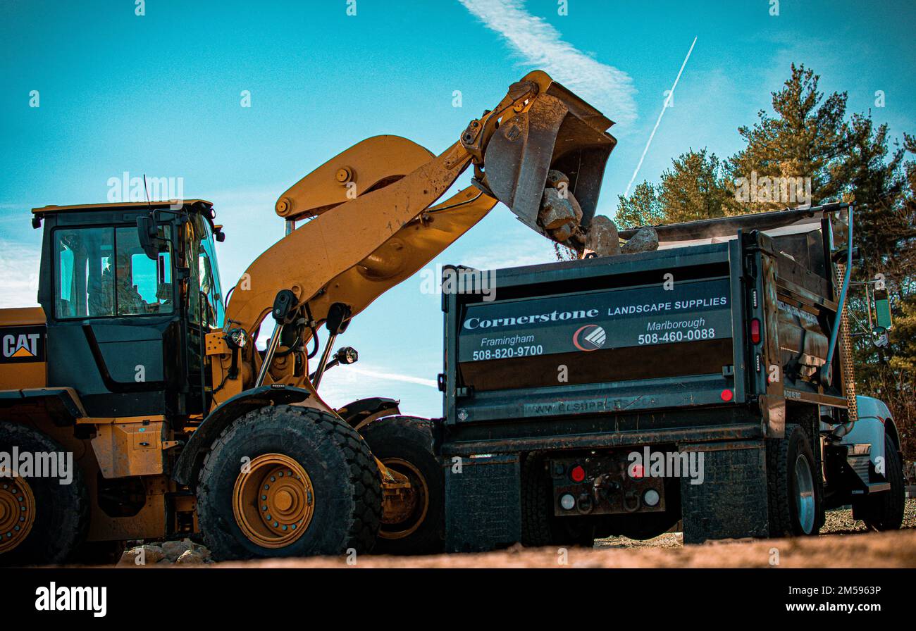 A front loader loading a truck. Marlborough, Massachusetts, USA Stock ...
