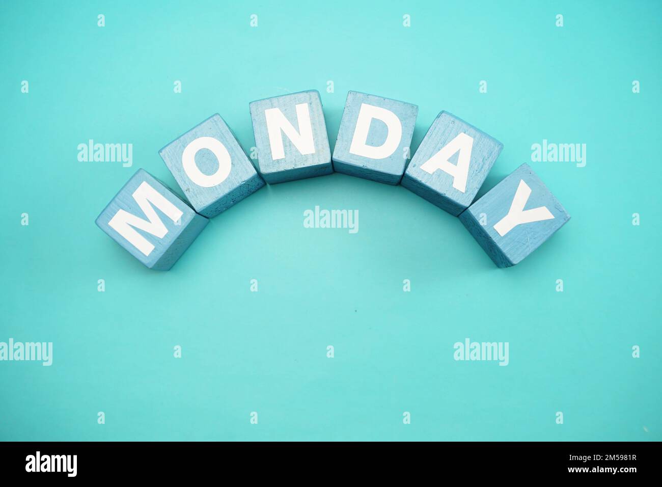 monday with blue wooden cubes alphabet letter on blue background Stock ...